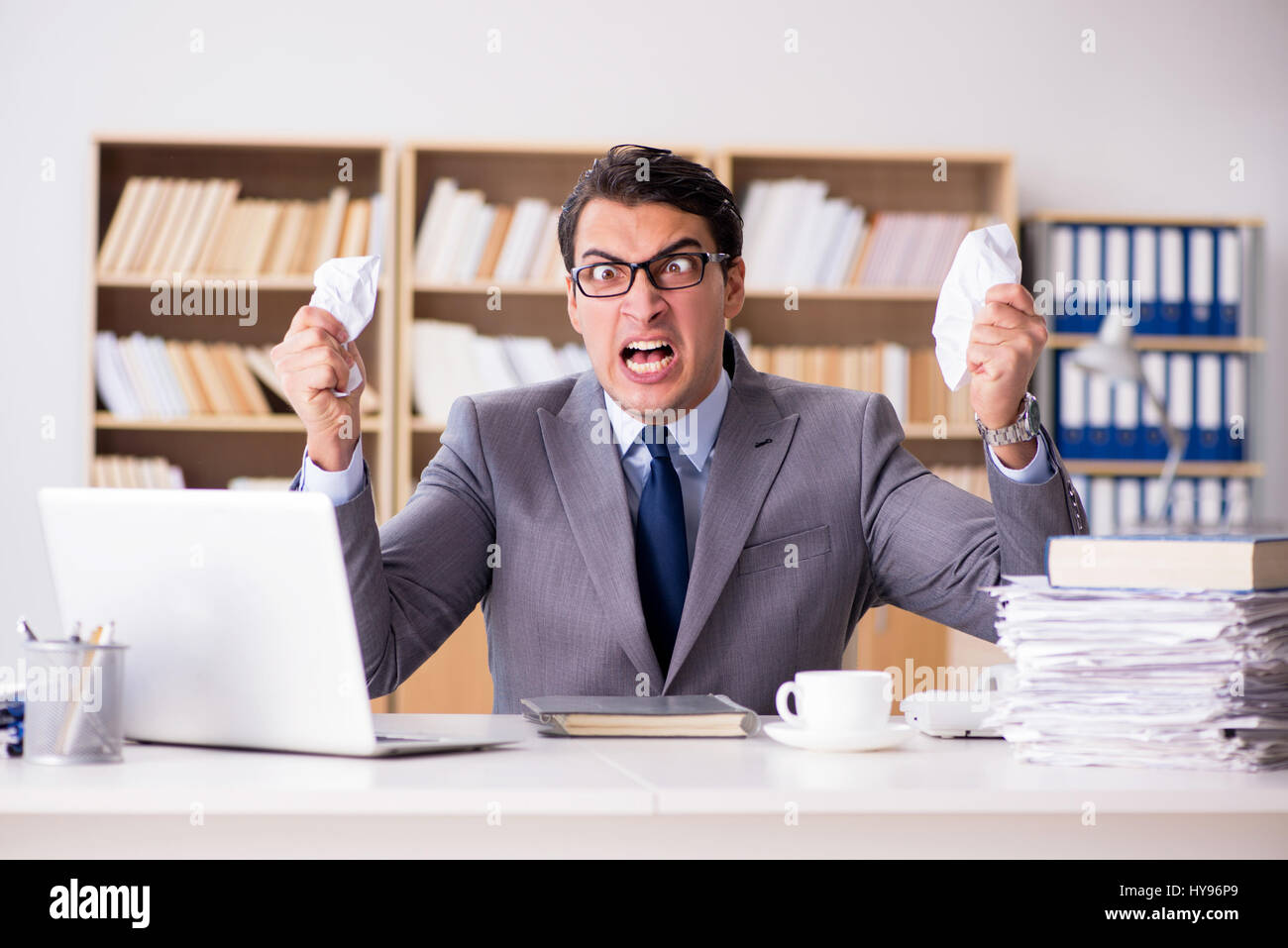 Angry businessman working in the office Stock Photo - Alamy