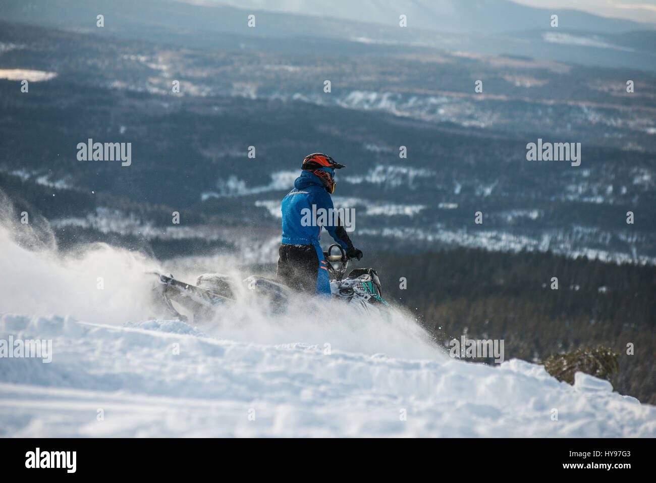 Rider on the snowmobile in the mountains Stock Photo - Alamy