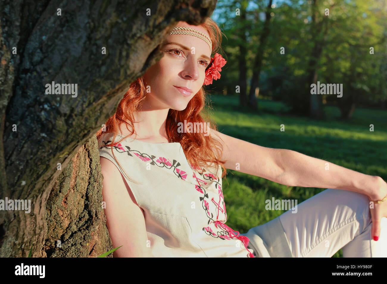 Girl in the spring walks through the apple alley in evening Stock Photo ...