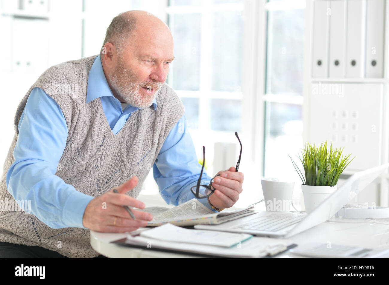 Elderly man with a laptop Stock Photo - Alamy