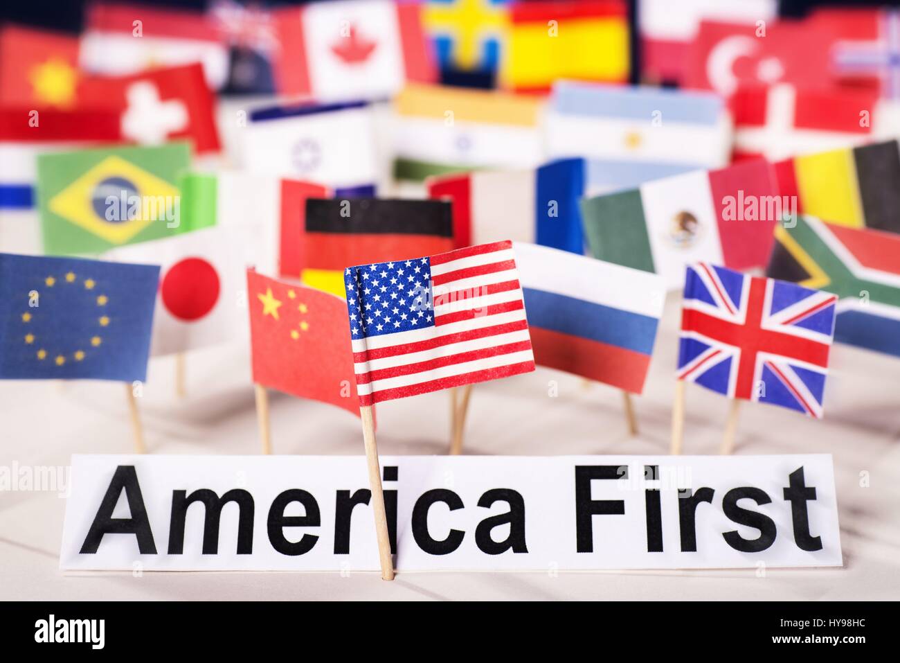 American flag is in front of the slogan America First and many flags of ...