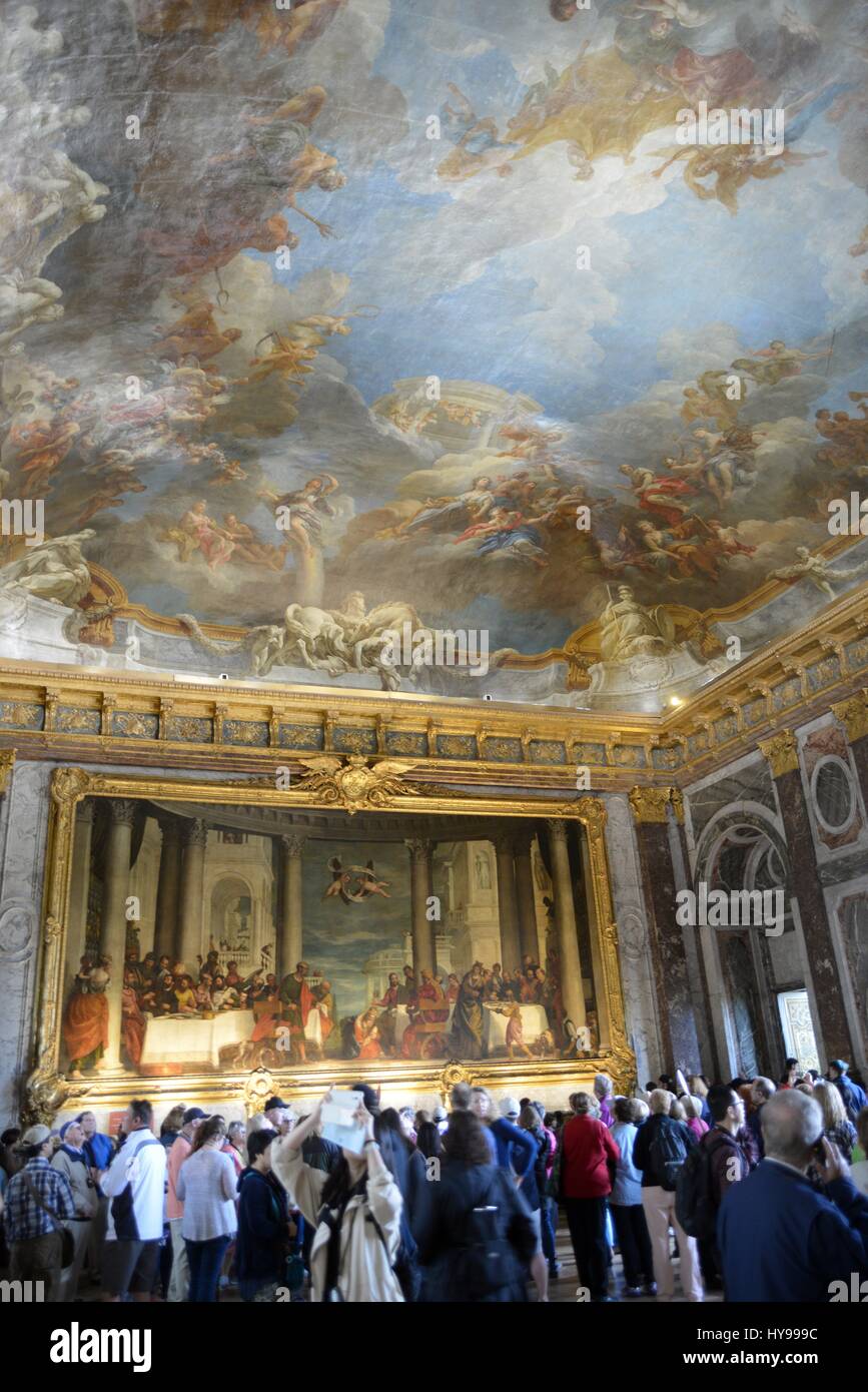 Tourists are looking at the Hercules Hall in the palace of Versailles ...