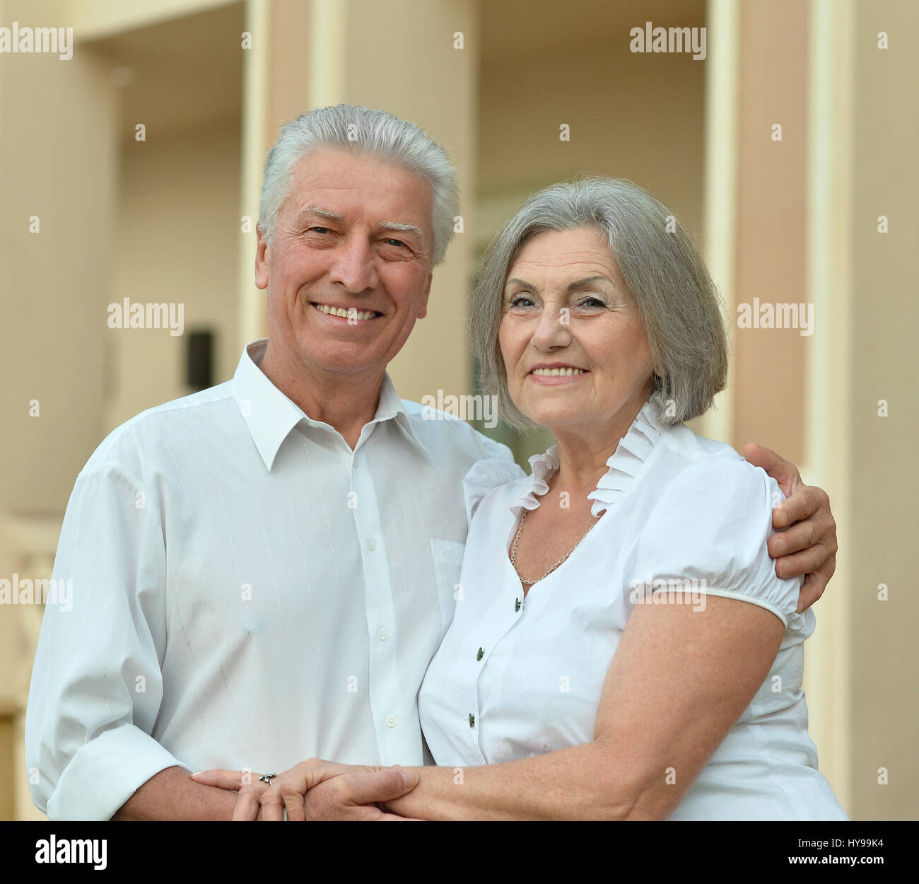 Happy elderly couple embracing Stock Photo - Alamy