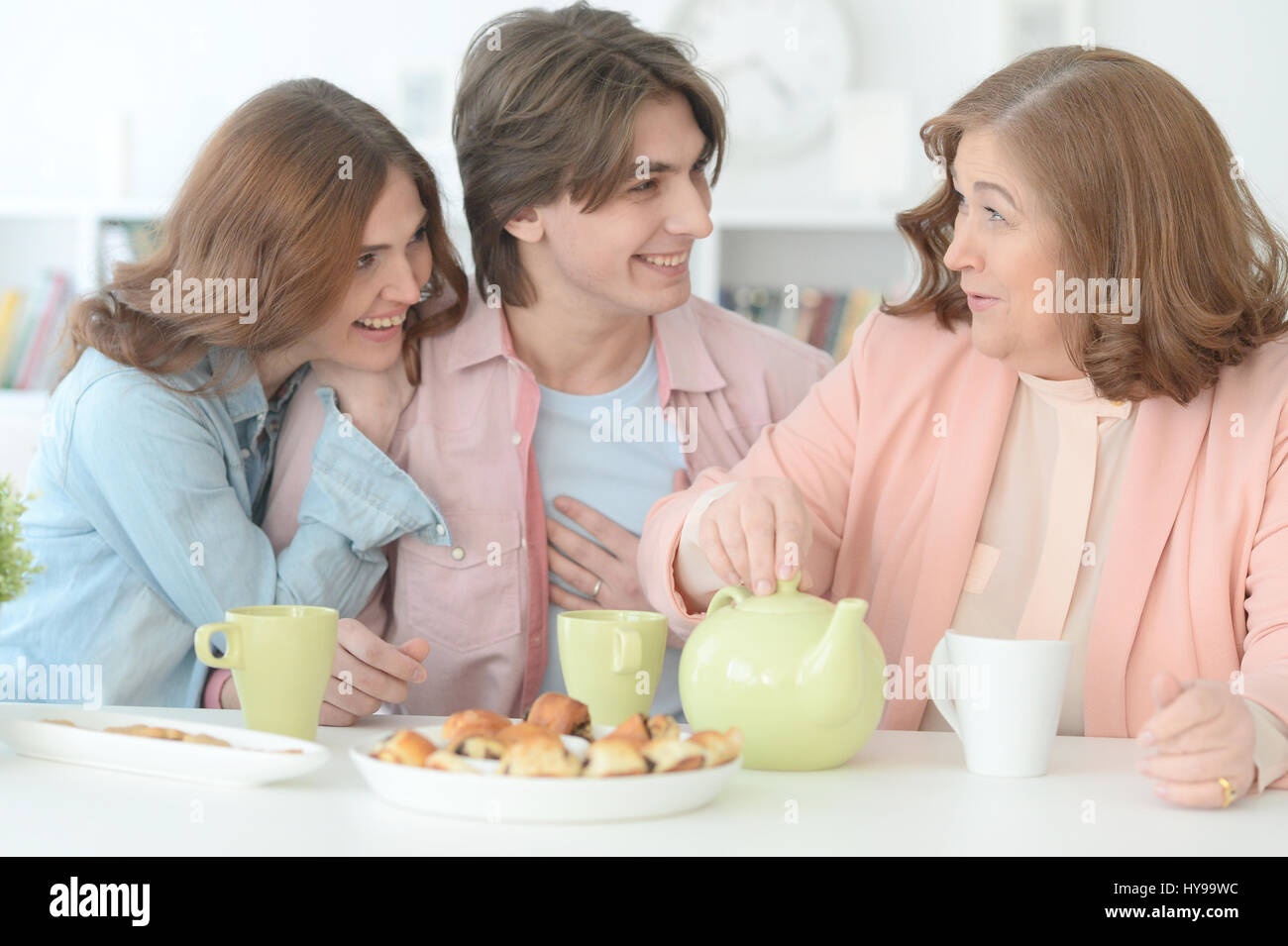 Happy family drinking tea together Stock Photo - Alamy