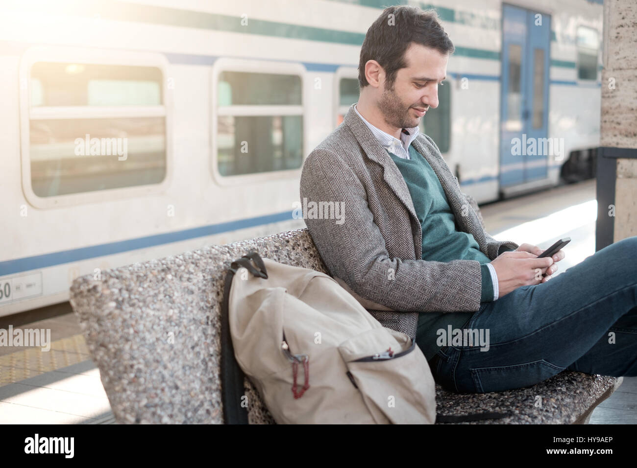 man waiting for the train seated in a train station platform Stock ...