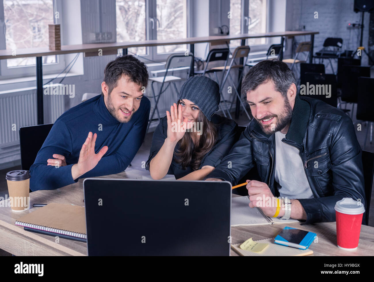 Video conference of young smart team. Group of modern people say hi ...