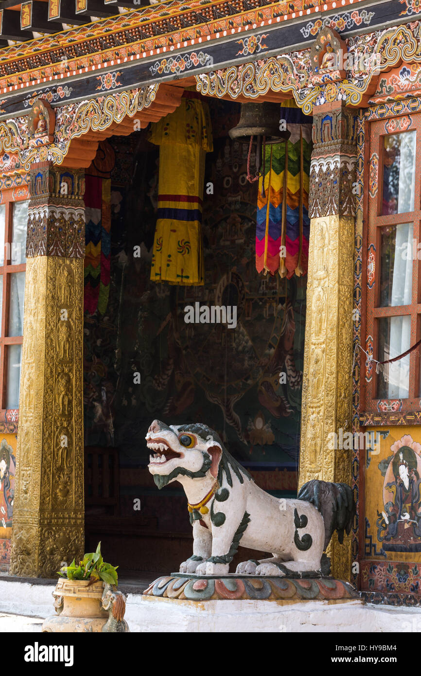 A mythical Tibetan snow lion guards the entrance to the Buddhist temple ...