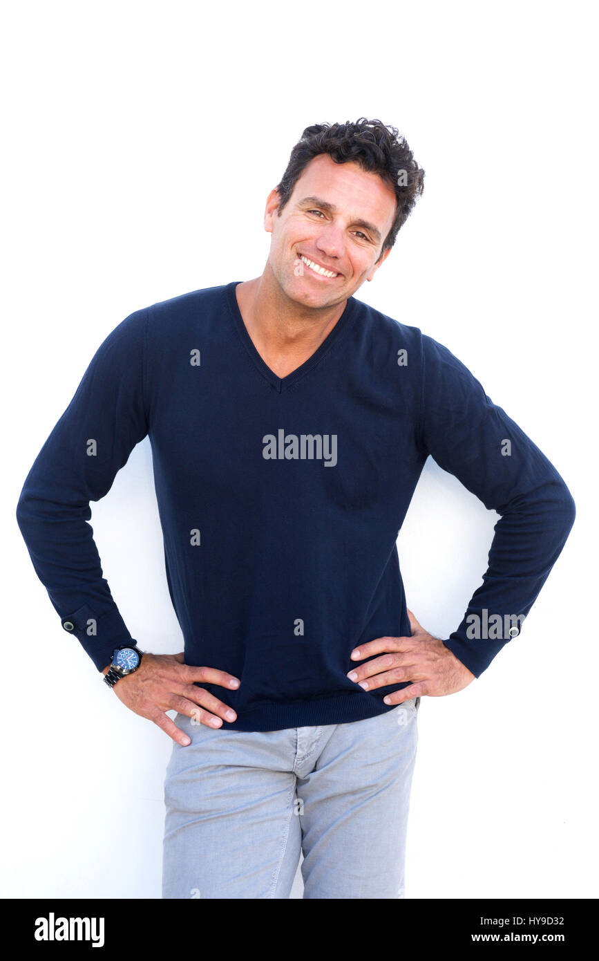 Portrait of a smiling middle aged man standing against white background ...