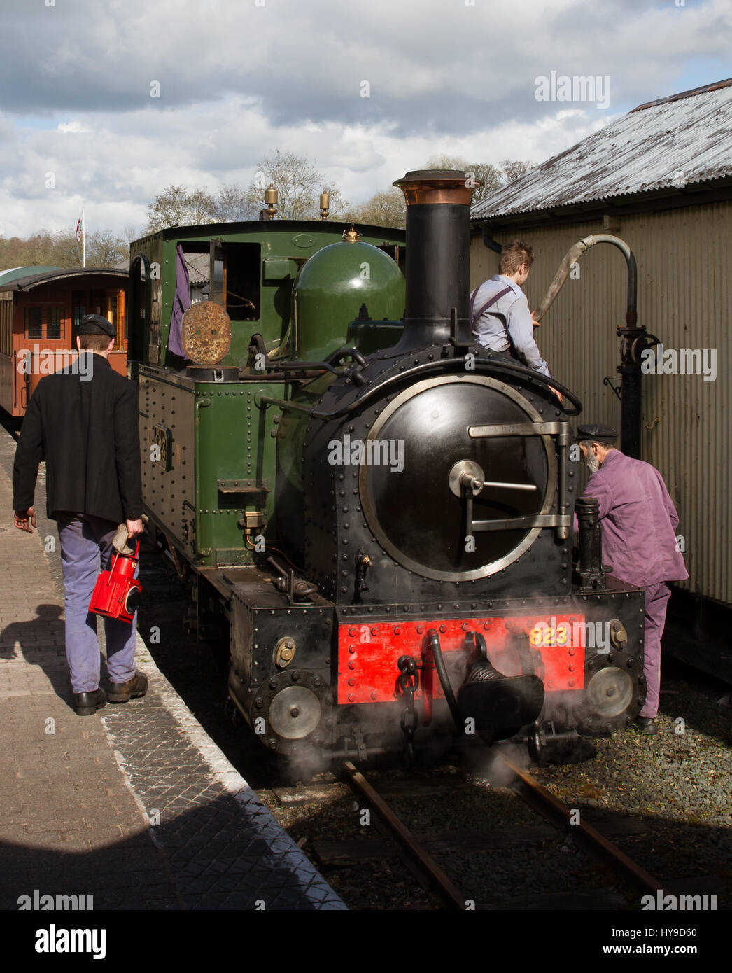 Steam train driver and fireman service the engine before the next ...