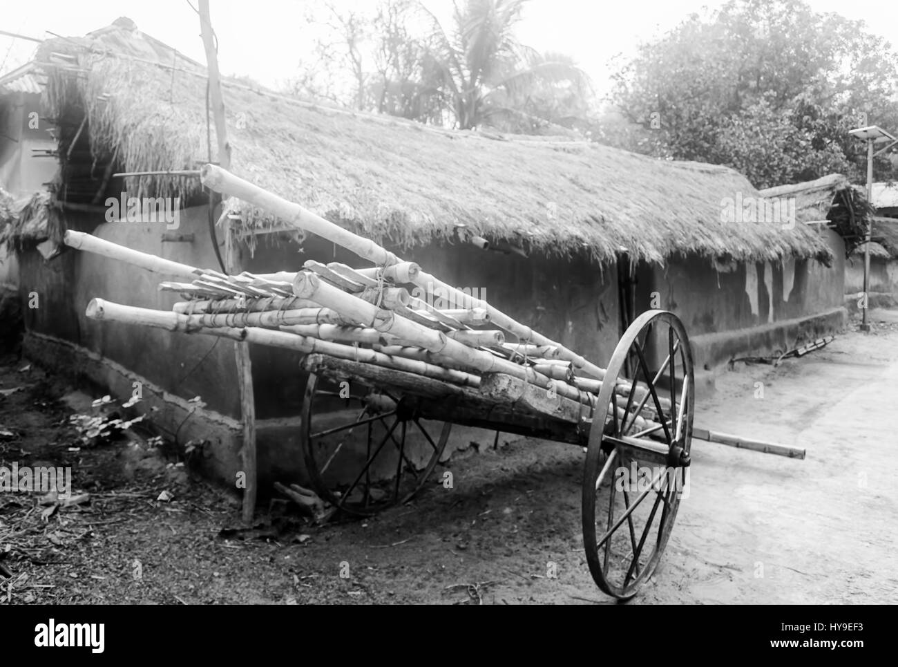 A bamboo made hand drawn cart in front of a mud house of a tribal ...