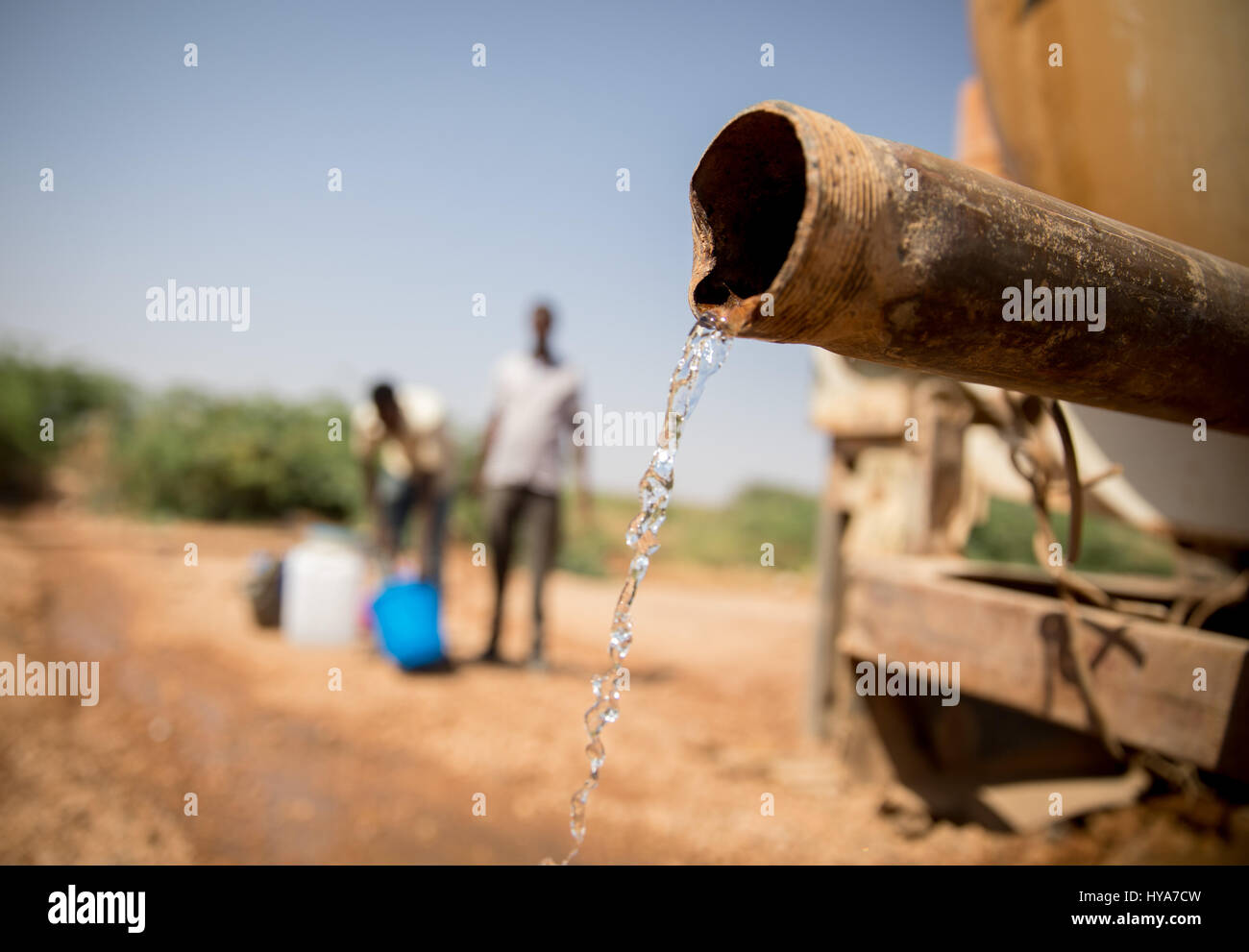 Water flows out of a tank at a water point in Kebri Dahar in the famine ...