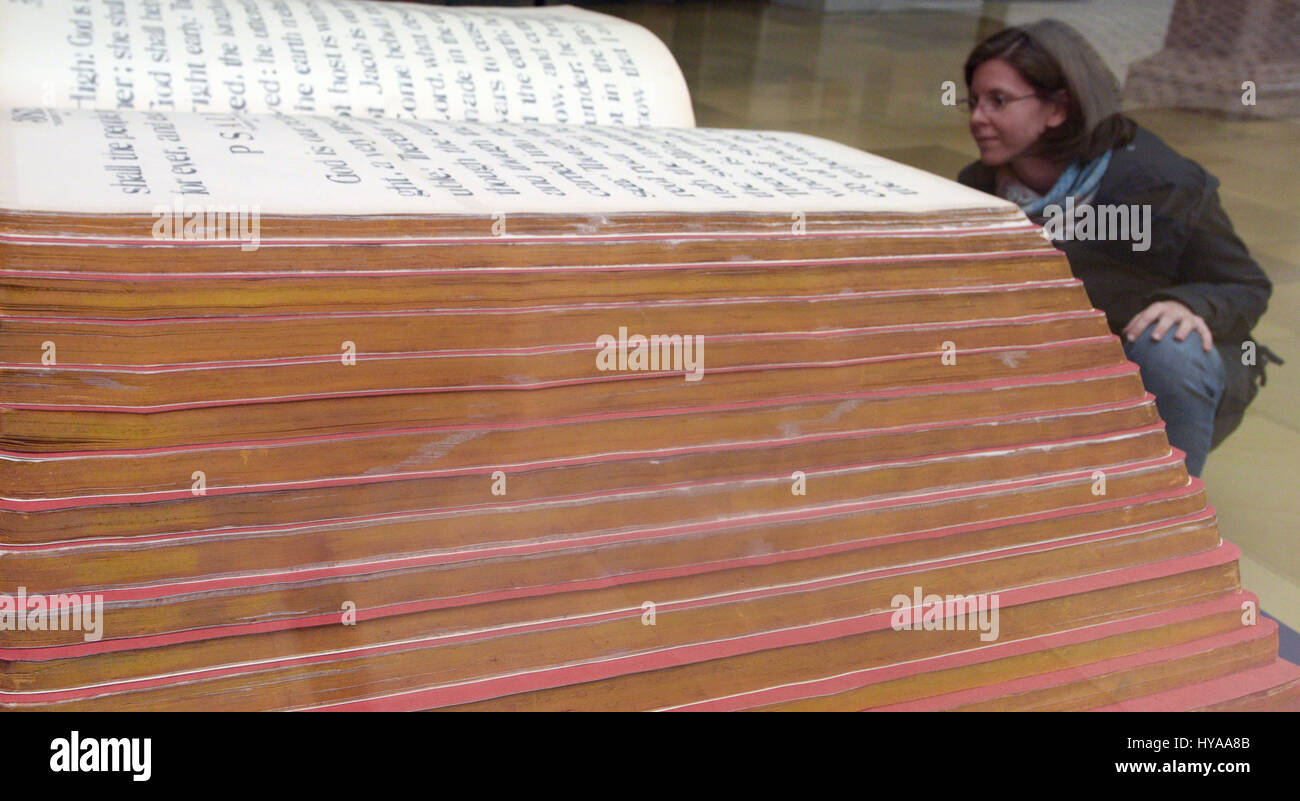 Augsburg, Germany. 6th Apr, 2017. A woman looks at the biggest bible in ...