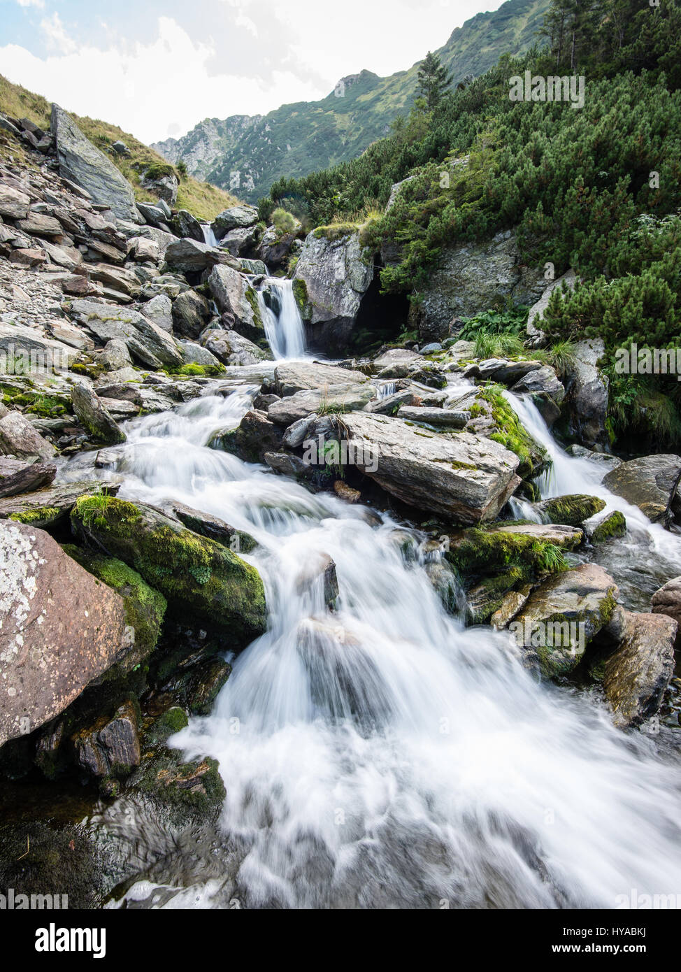 Waterfall from ravine in mountain river in rocks Stock Photo - Alamy