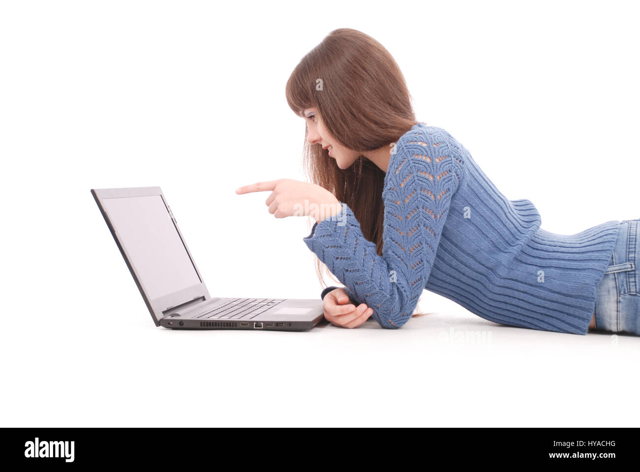 Young woman lying on floor using laptop. Young caucasian woman lying ...