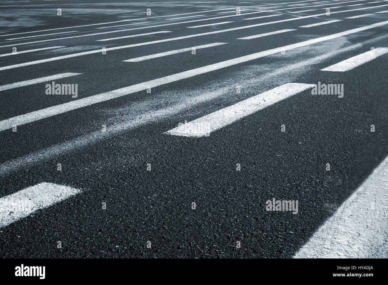 Lines on wet wide asphalt road perspective view. Texture and background ...