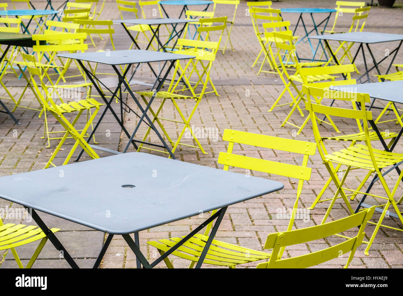Close up view of empty folding tables and neon green folding chairs on ...