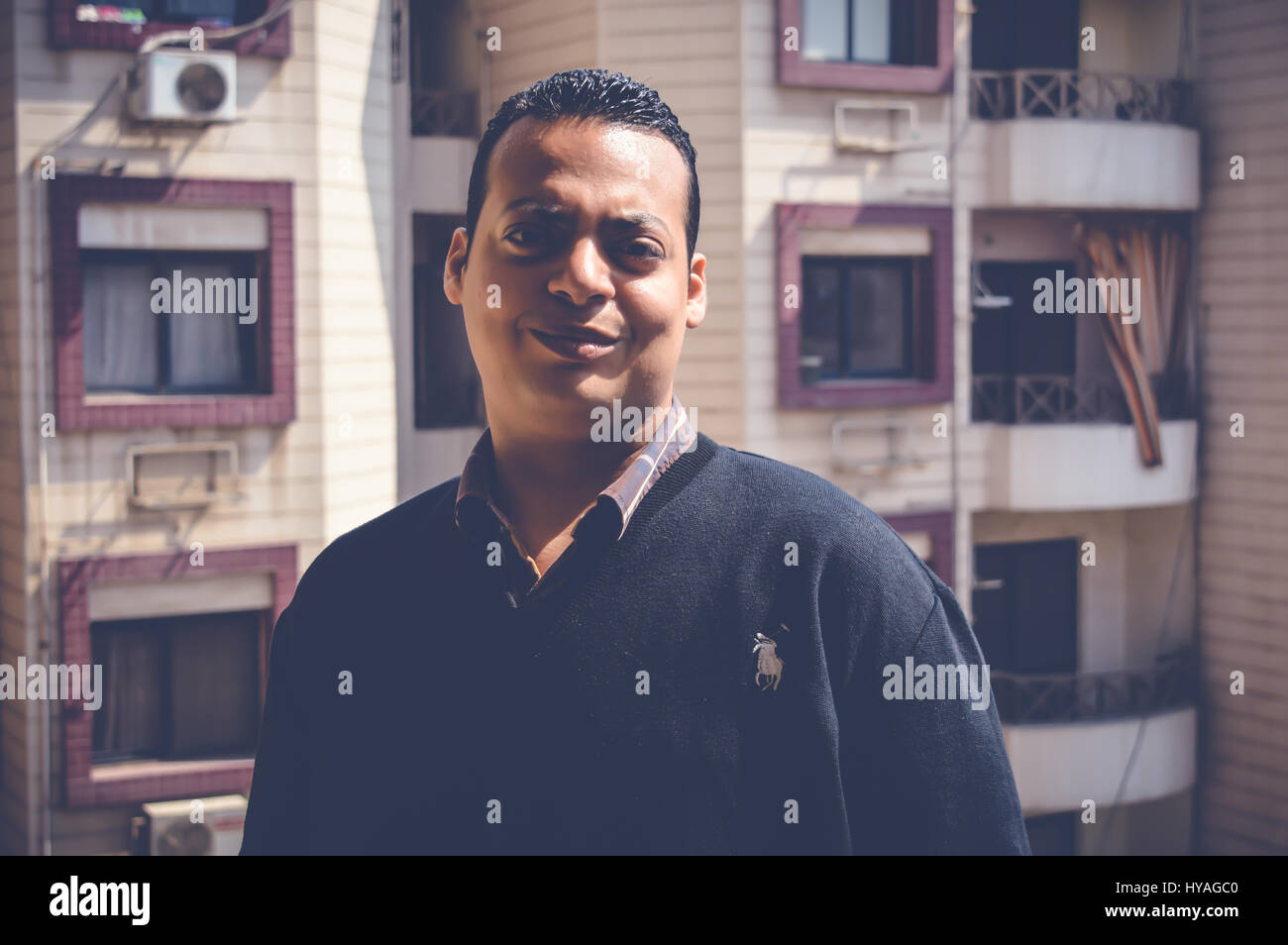 portrait of young business man with building background Stock Photo - Alamy