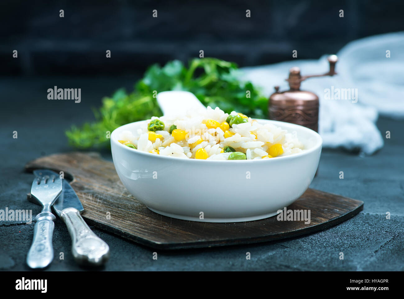 rice with vegetables in bowl and on a table Stock Photo - Alamy