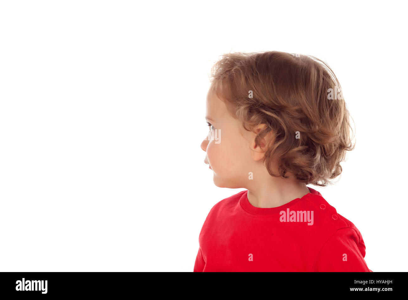 Adorable baby with two years old and red jersey looking to the side ...