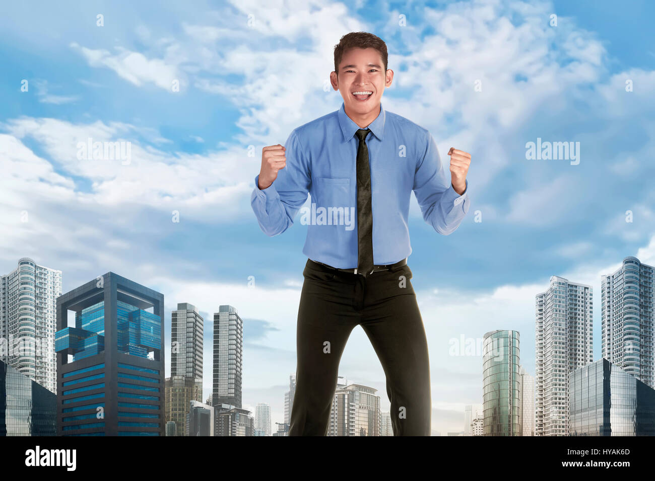 Happy asian businessman with spirit expression over skyscraper ...