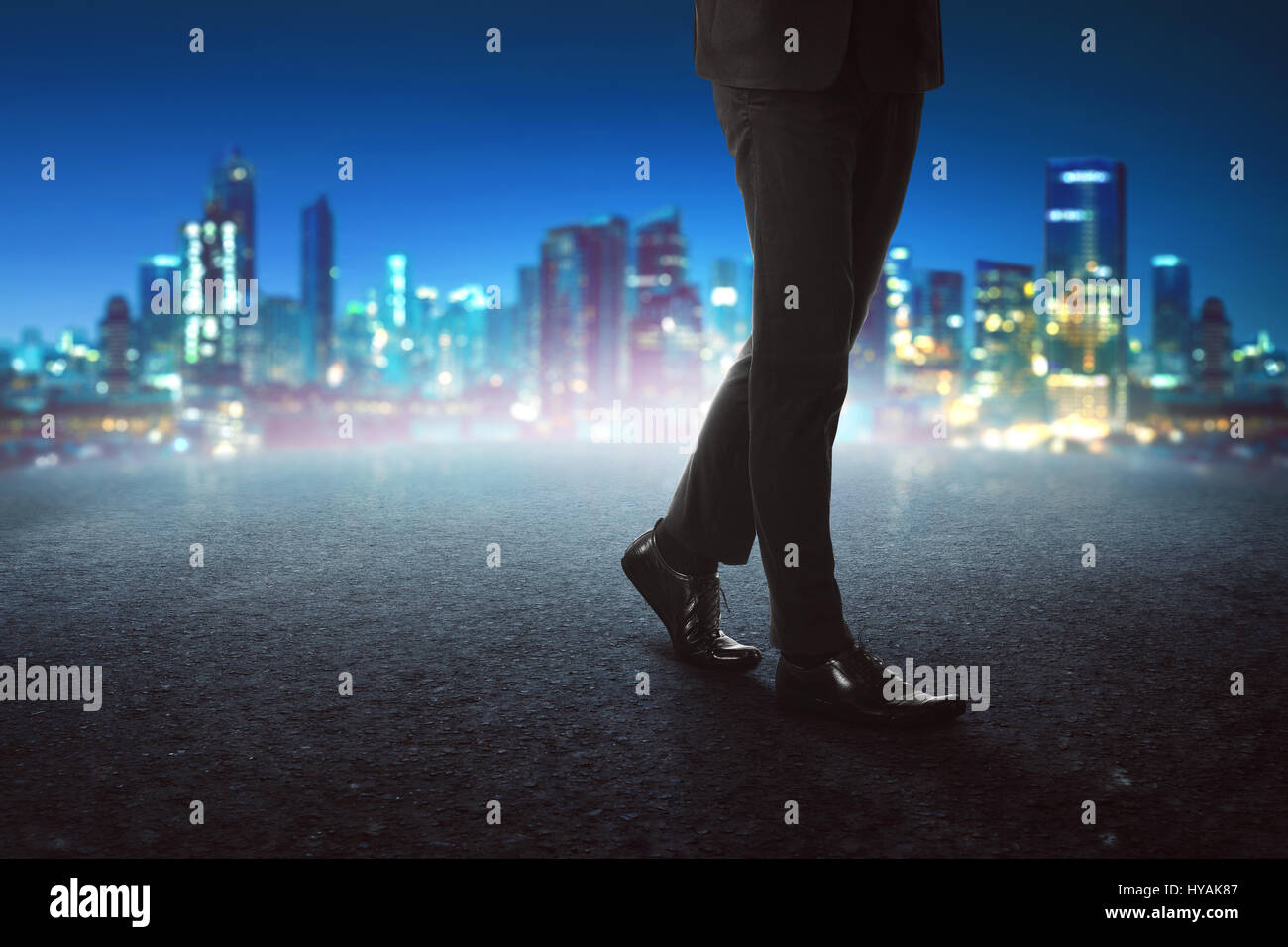 Businessman legs wearing black shoes walking on concrete with cityscape ...