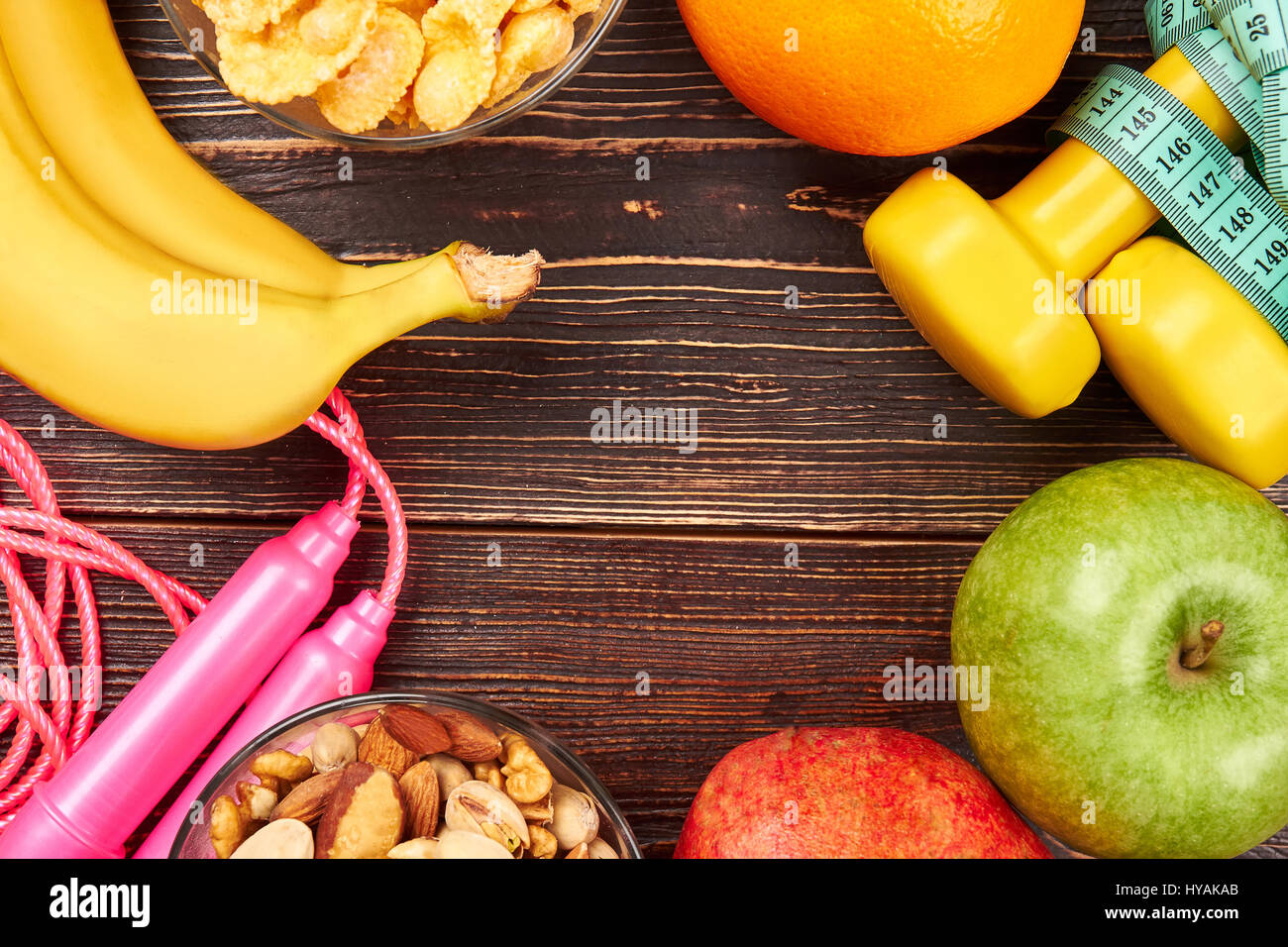 Bananas, apple and skipping rope. Healthy food and sport tools. Develop ...