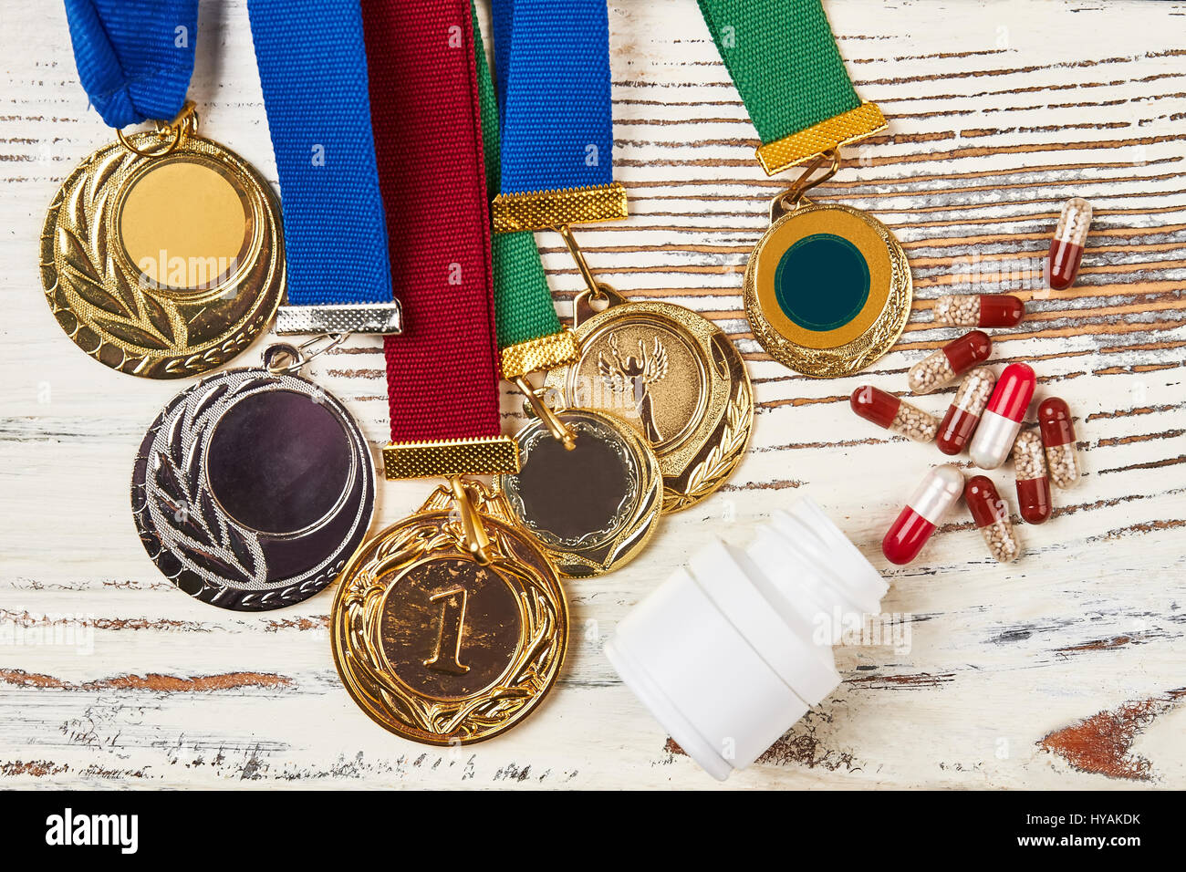 Medals and container with pills. Use of doping in sport Stock Photo - Alamy