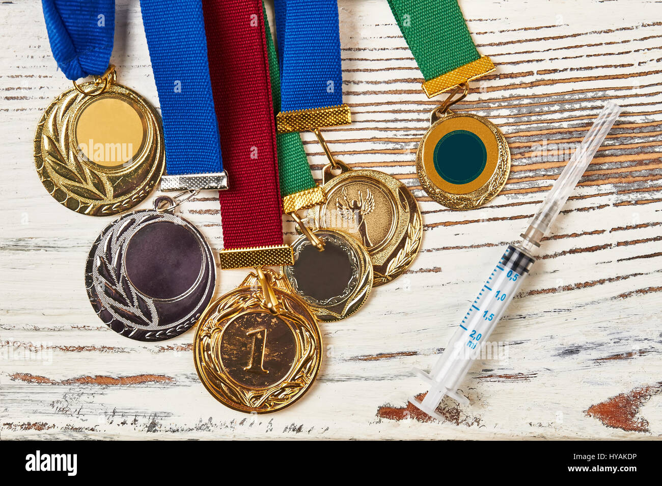 Medals and syringe on wood Stock Photo - Alamy