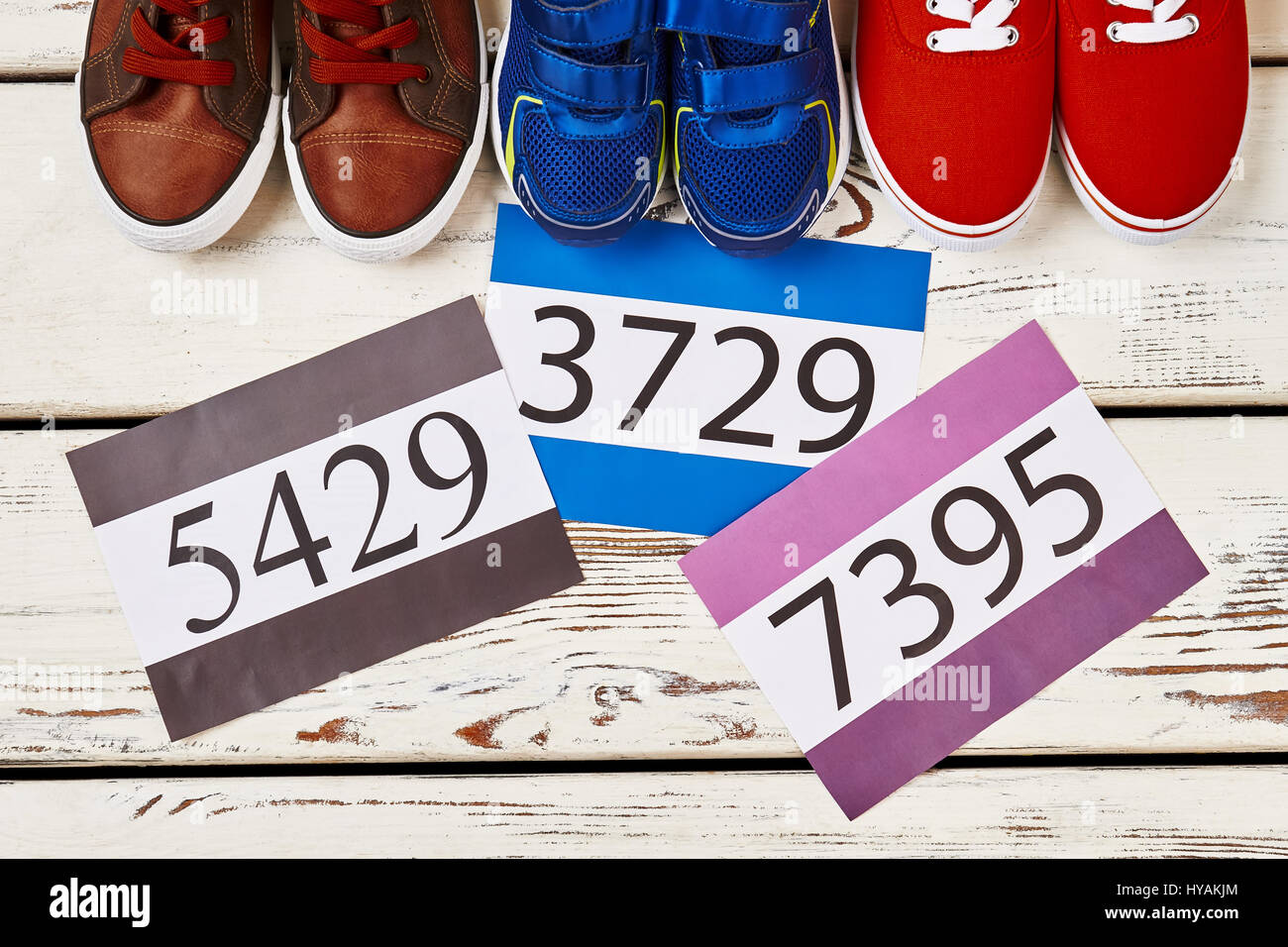 Sneakers and numbers on wood Stock Photo - Alamy