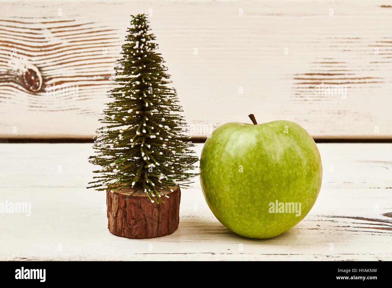 Fir-tree and apple on wood Stock Photo - Alamy