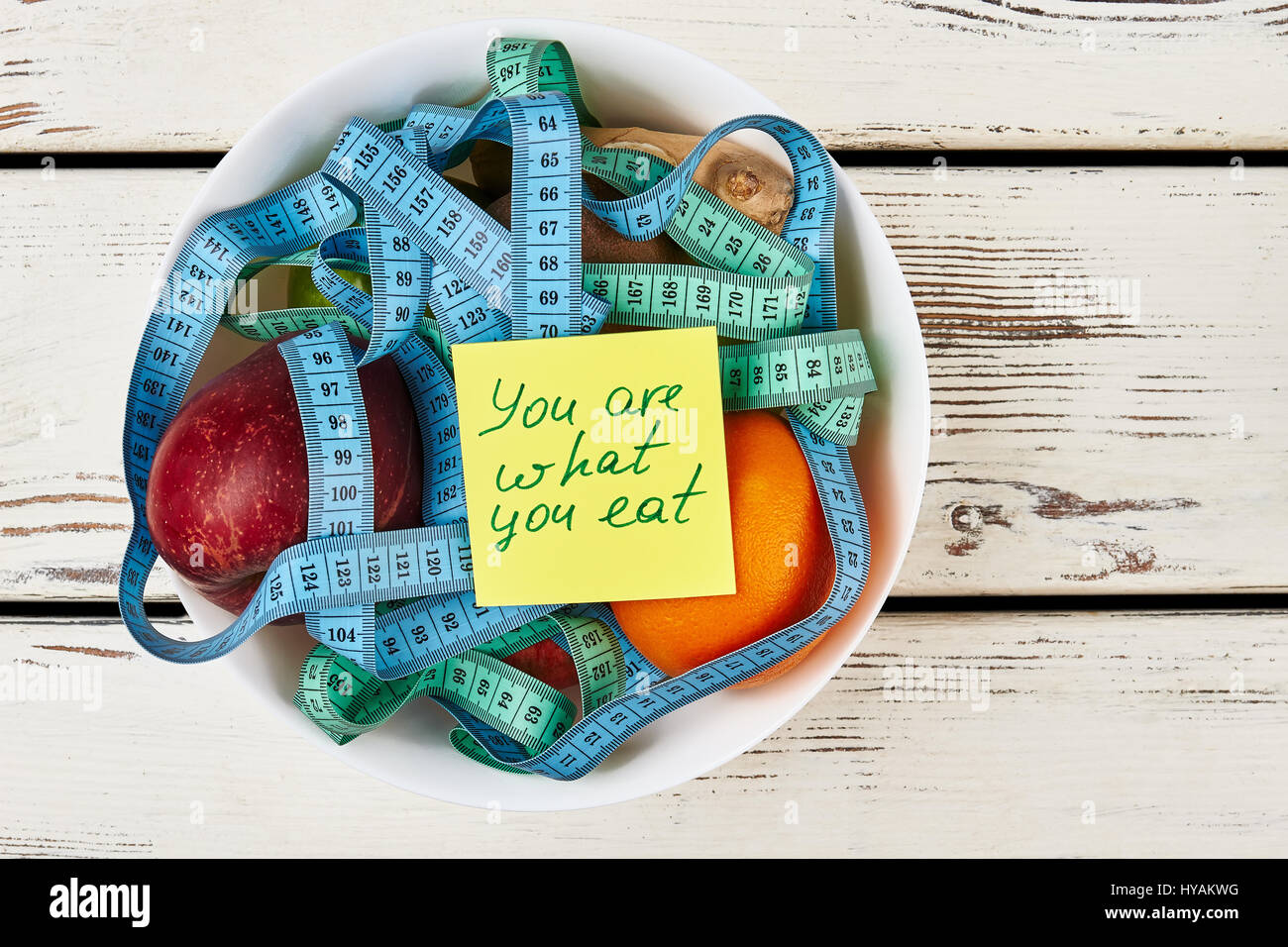 Note and bowl with fruits Stock Photo - Alamy