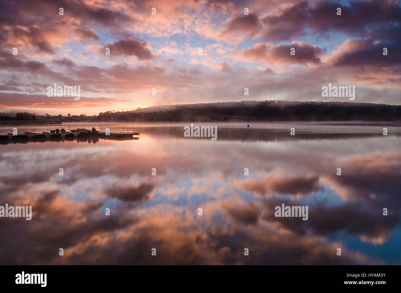 WIMBLEBALL LAKE, SOMERSET, UK: Sunset is perfectly reflected in the ...