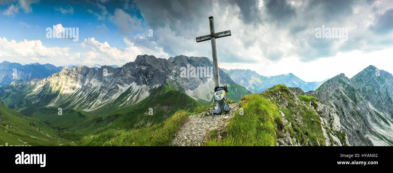 Wooden summit cross and summer colors in mountains. Panoramic view ...