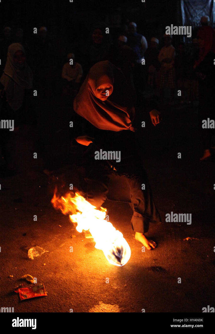 Indonesian muslim women playing a fire football on the street during ...