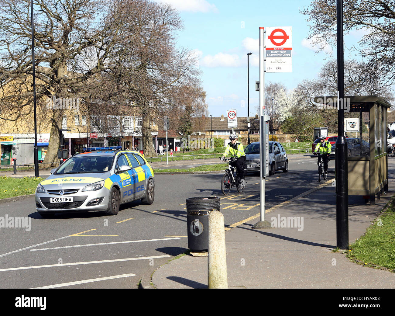Police officers pass bus stop hi-res stock photography and images - Alamy