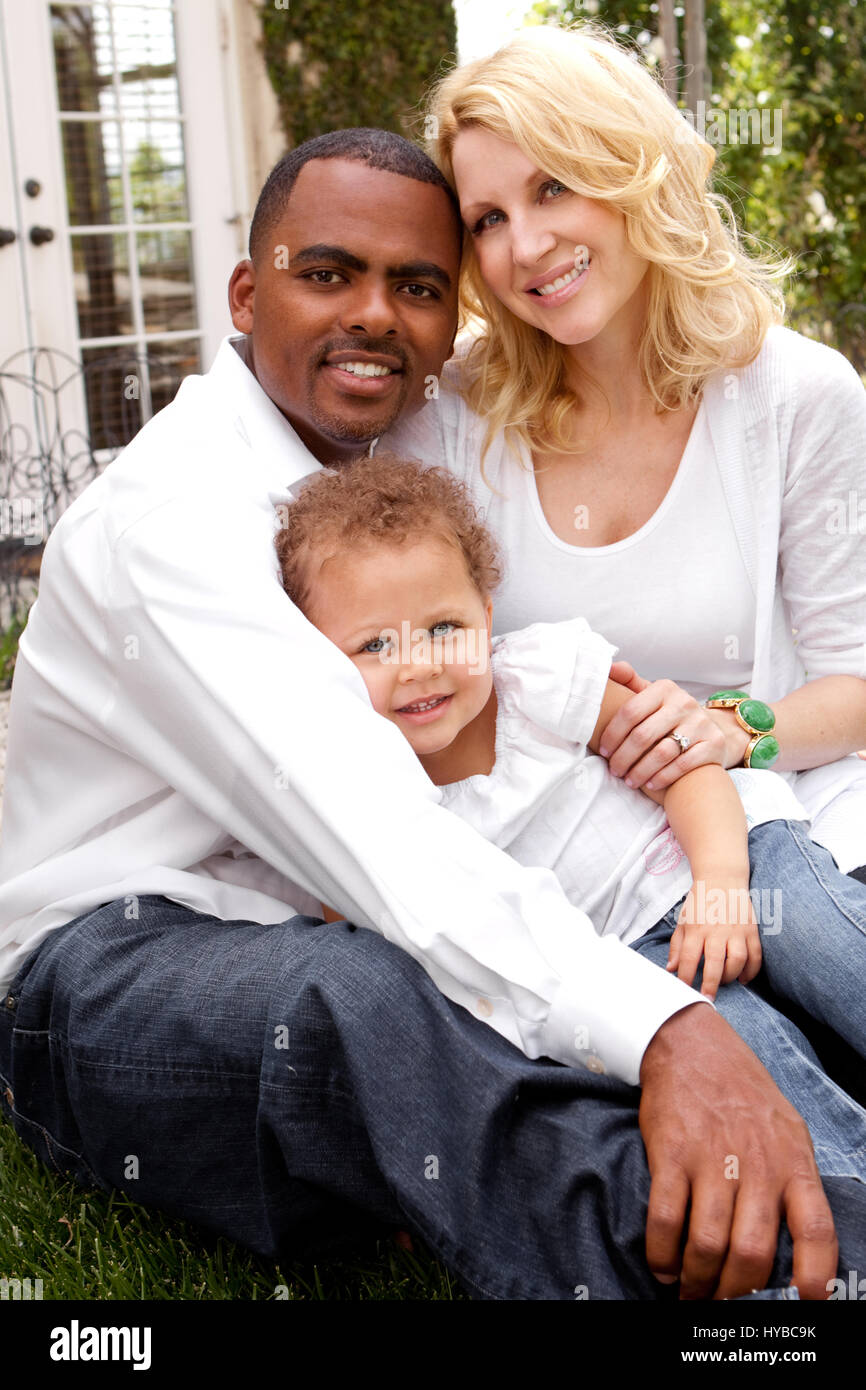 Happy mixed race family laughing and smiling outside Stock Photo - Alamy