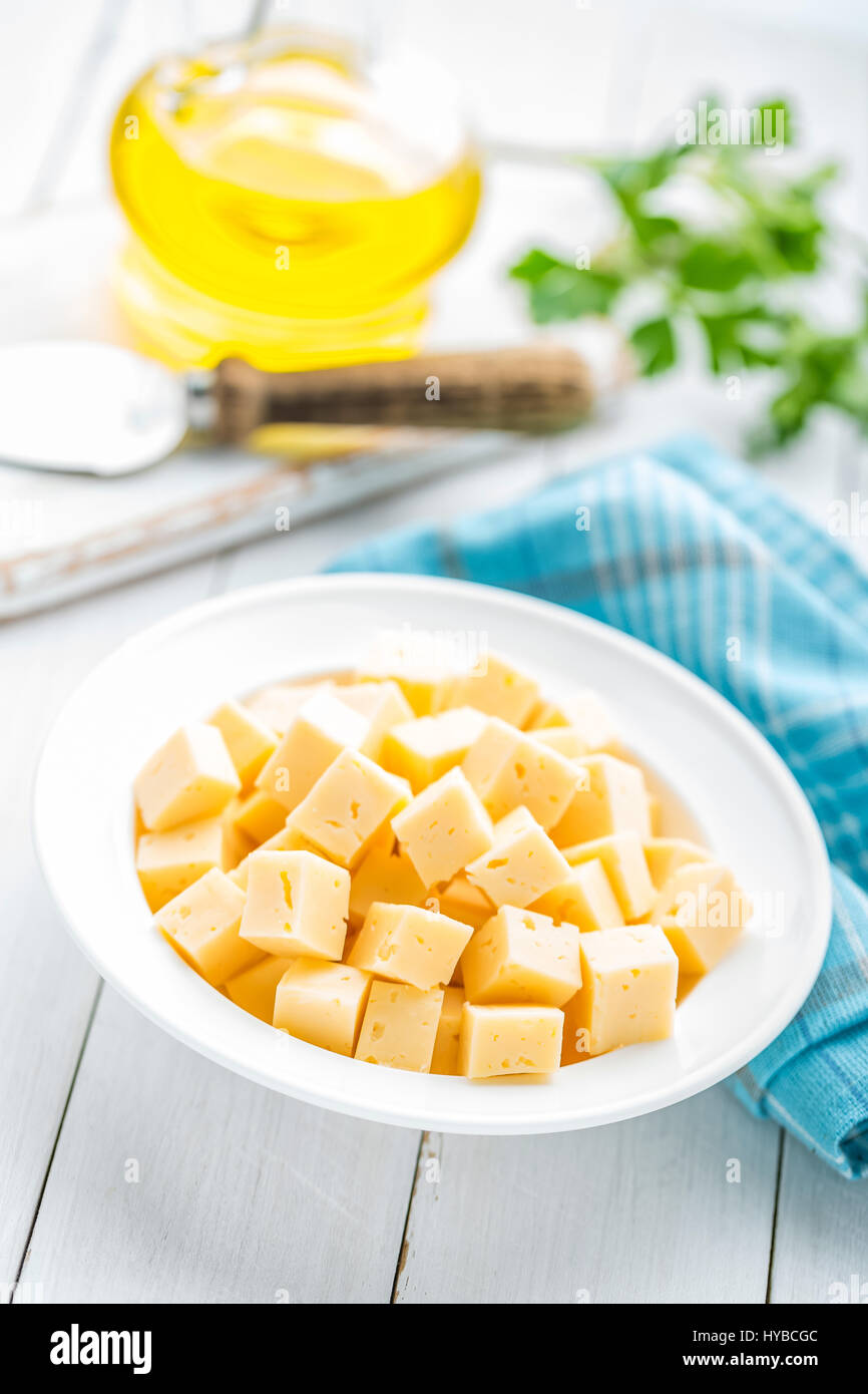Cheese slices on plate, white background Stock Photo - Alamy