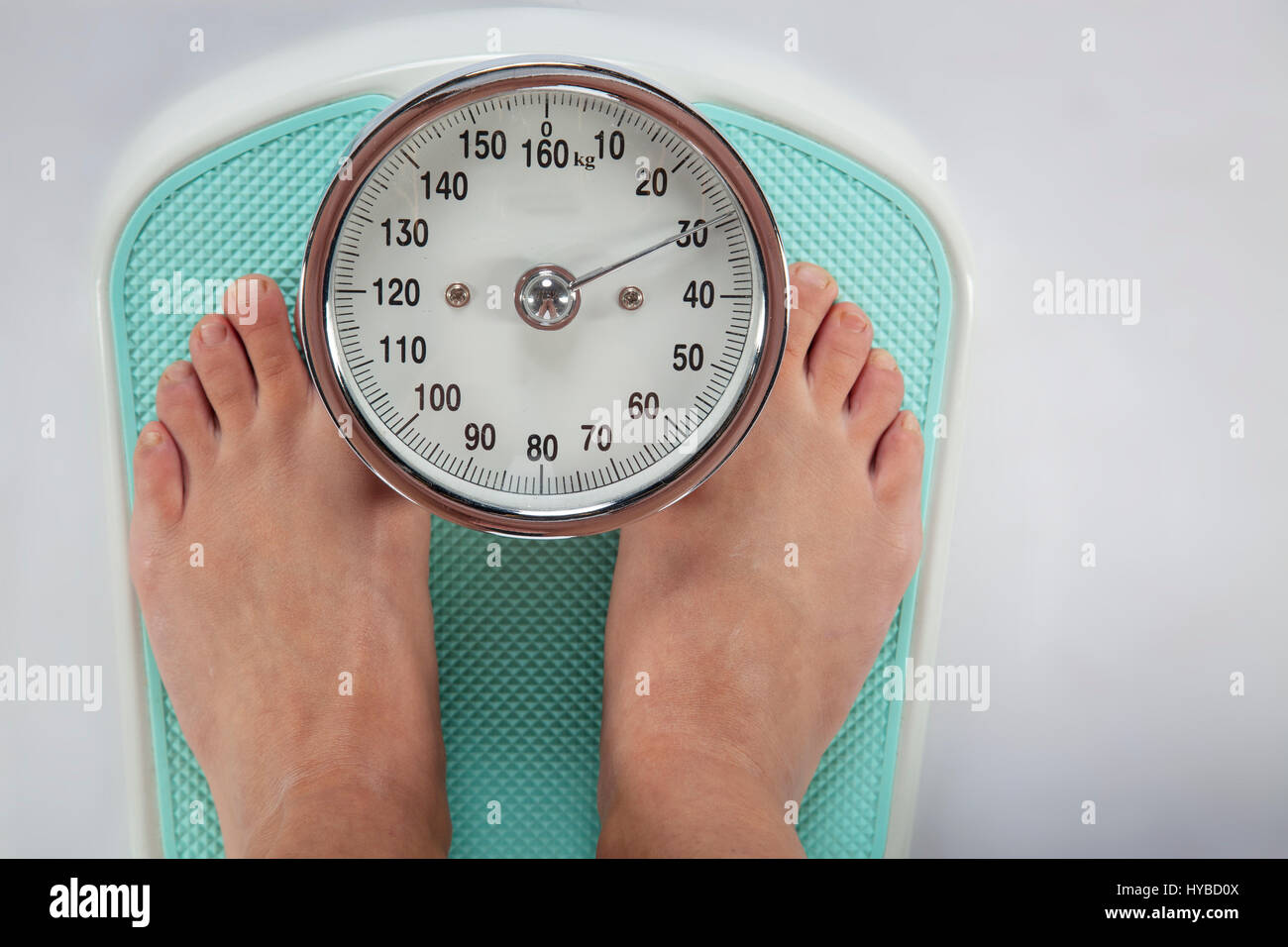 Woman's legs on weight Stock Photo - Alamy