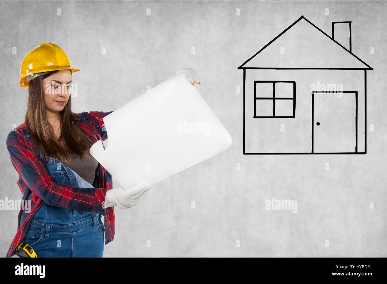Construction worker looking at plans, new house Stock Photo - Alamy