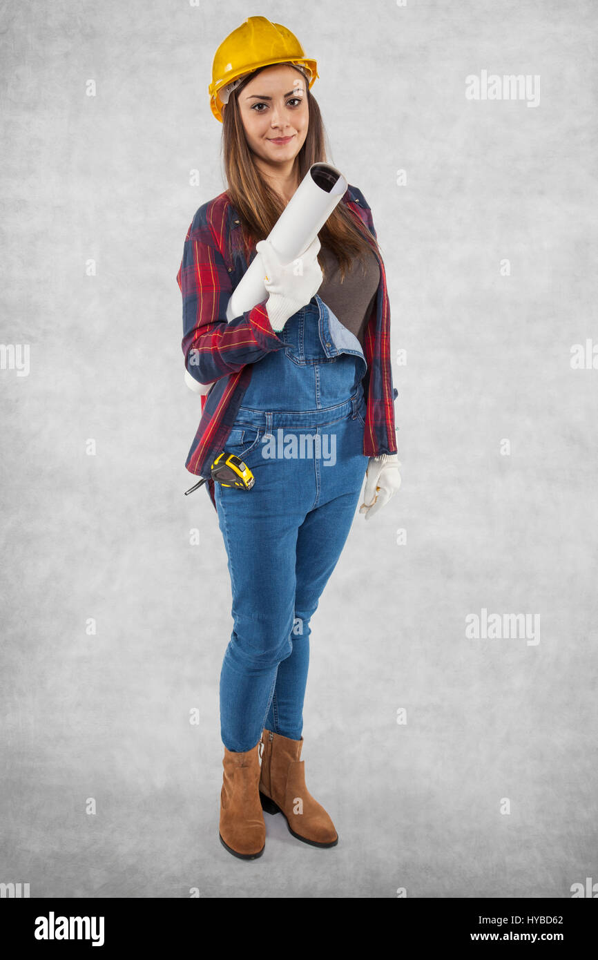Female construction worker poses for photo, plans in hand Stock Photo ...