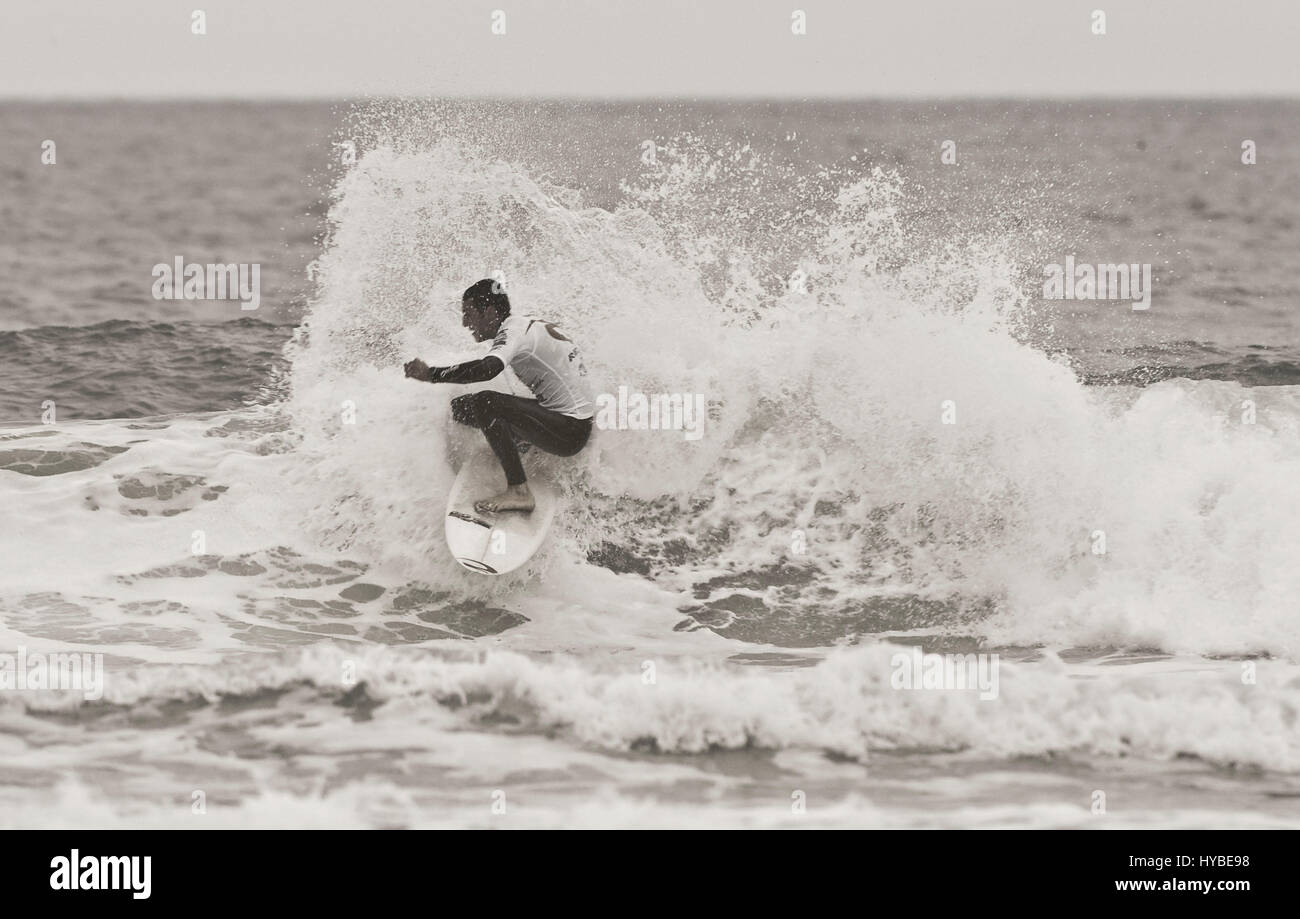Black and white image of surfer riding a white choppy wave Stock Photo ...