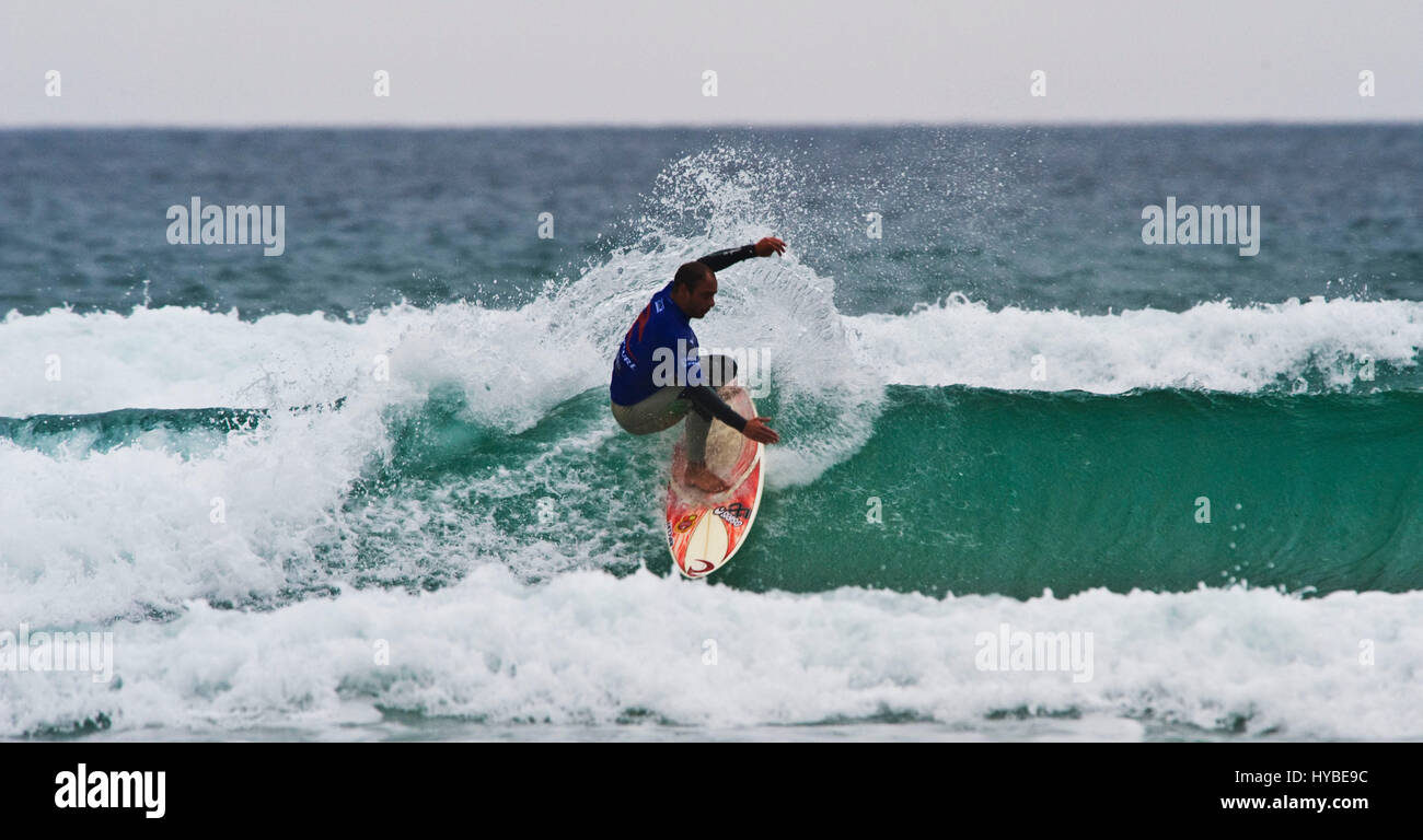 Surfer riding the waves at a beach in Newquay Stock Photo - Alamy