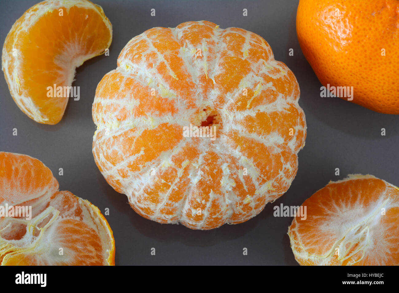 high angle view of a closeup of peeled and unpeeled whole mandarin and ...