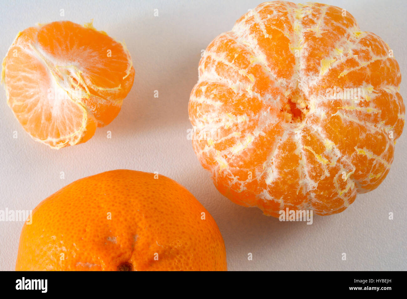 high angle view of a closeup of peeled and unpeeled whole mandarin and ...