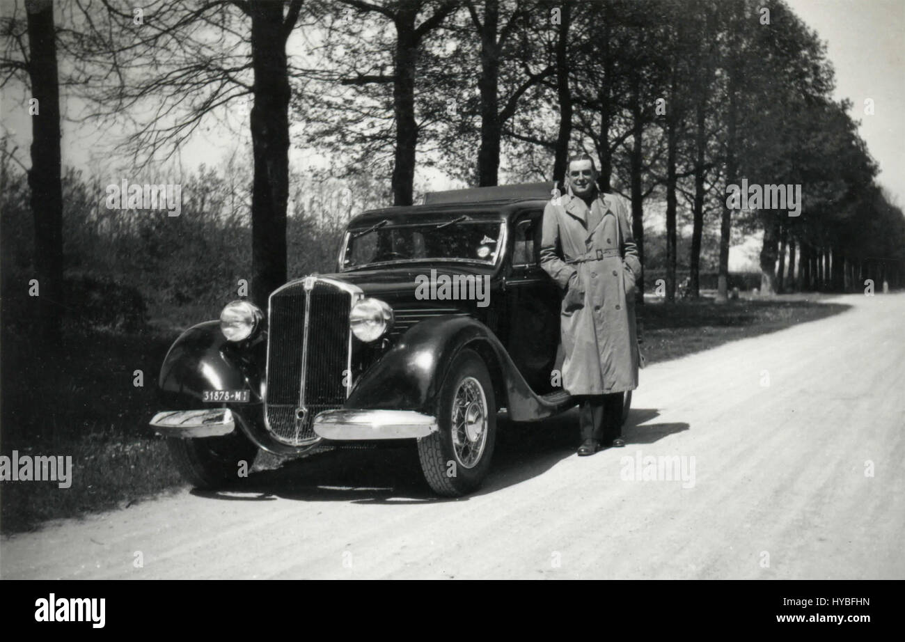A man posing with his car on the road, Italy Stock Photo - Alamy