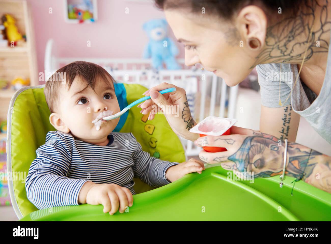 Mummy feeding boy with yoghurt Stock Photo - Alamy