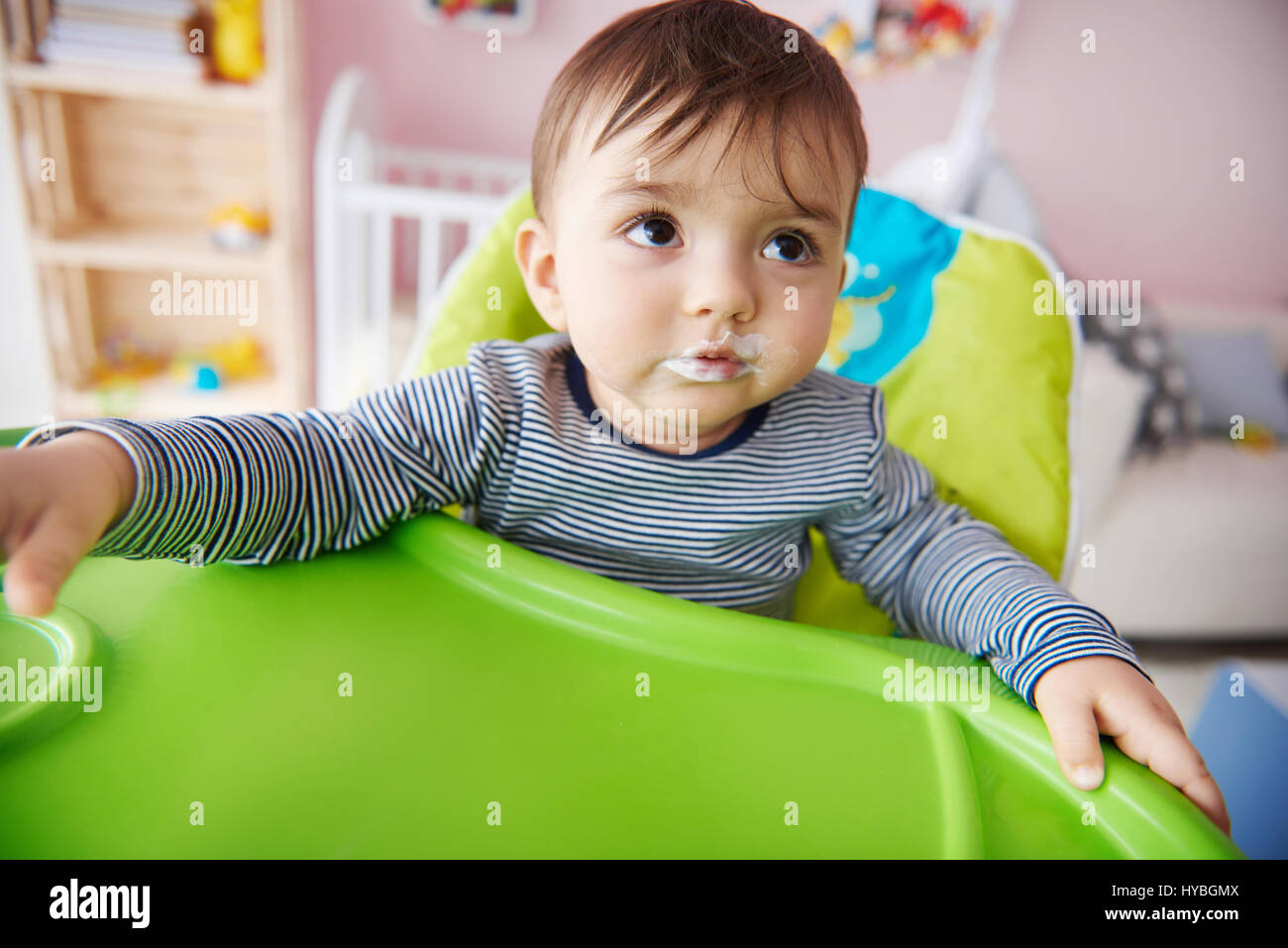 Sitting smiling childhood looking away chair hi-res stock photography ...