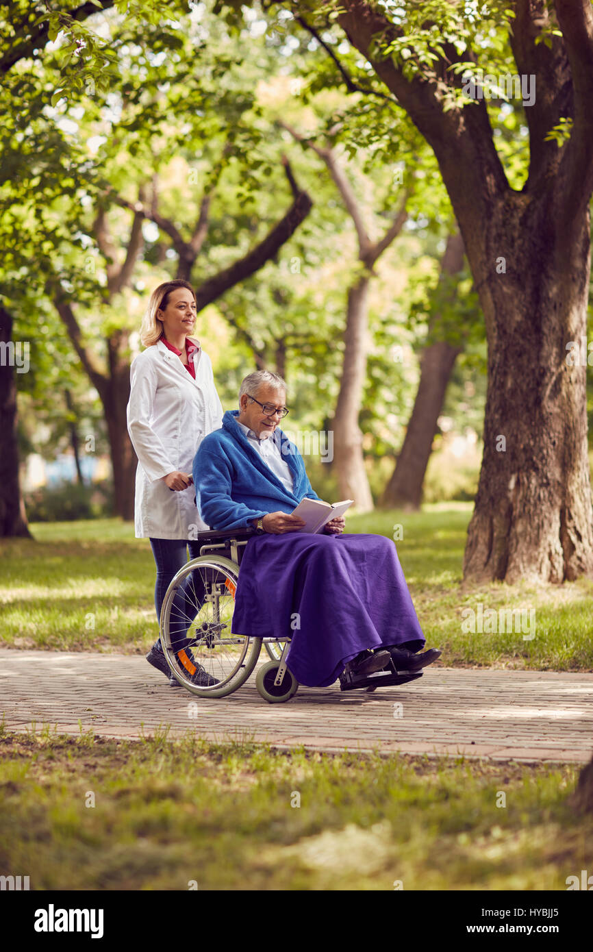 Old man pushing wheelchair hi-res stock photography and images - Alamy