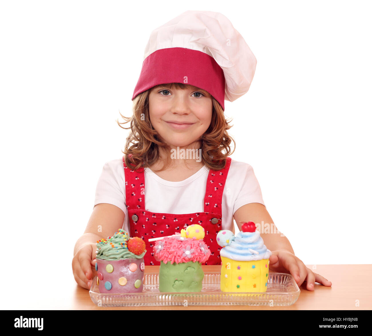 beautiful little girl cook with cupcakes Stock Photo - Alamy