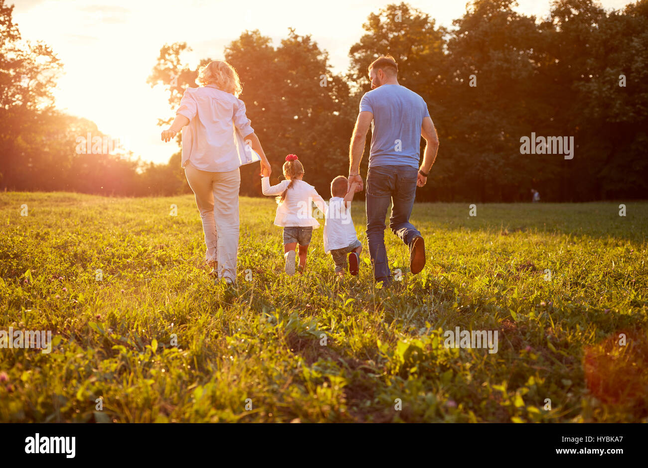 Family running together Family in nature, back view Stock Photo - Alamy